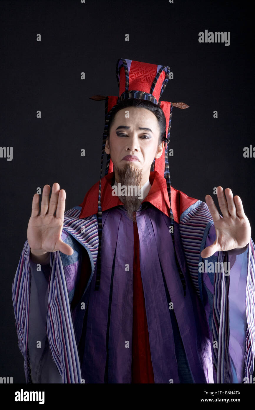 A man wearing traditional king clothing showing hands Stock Photo - Alamy