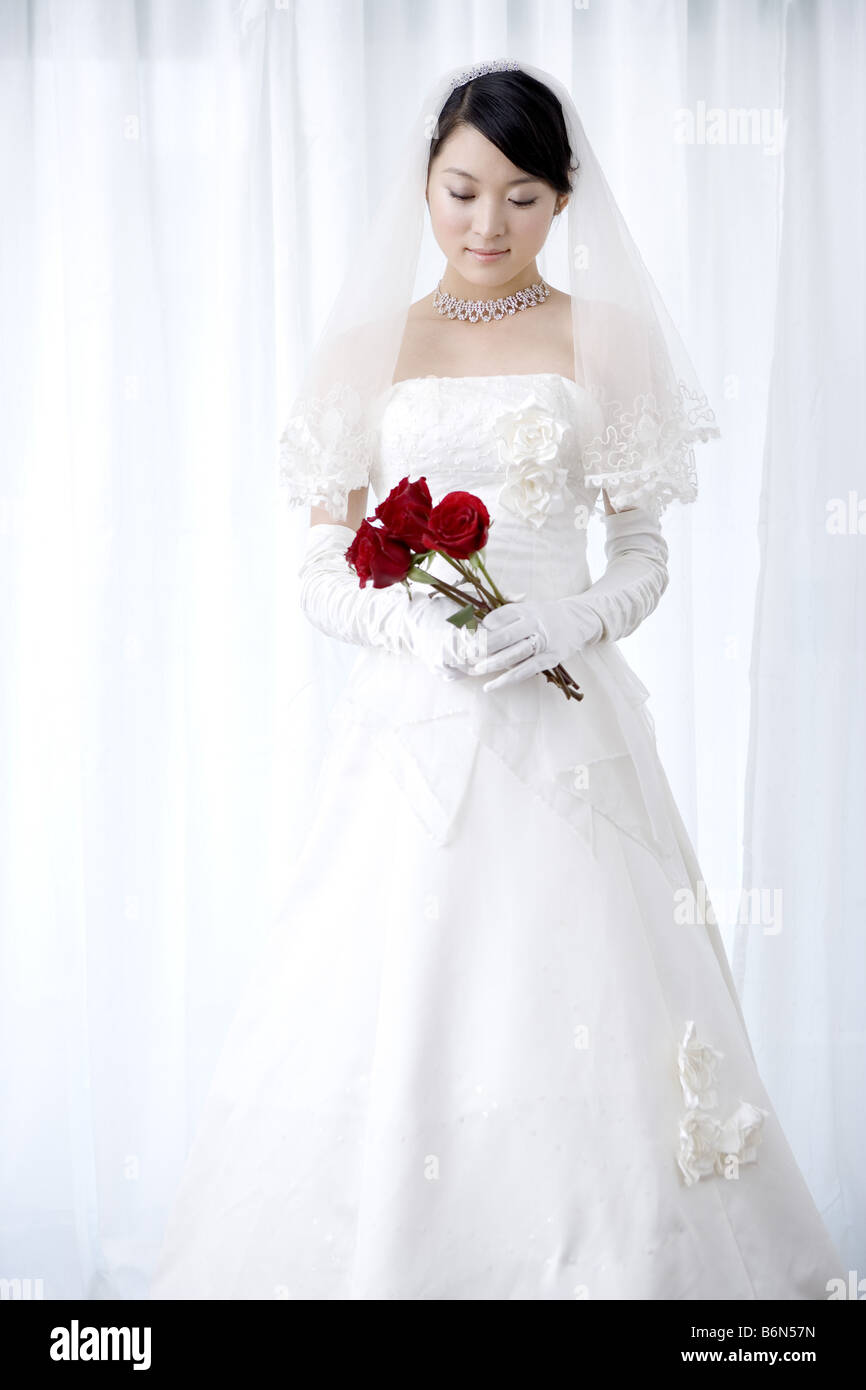 Young bride with three roses Stock Photo - Alamy
