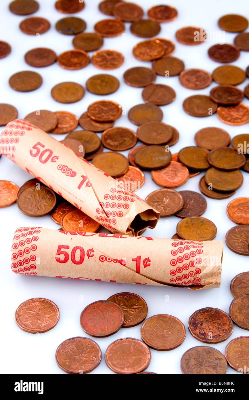 Concept of paper coin rollers amoung pennies on white background ...