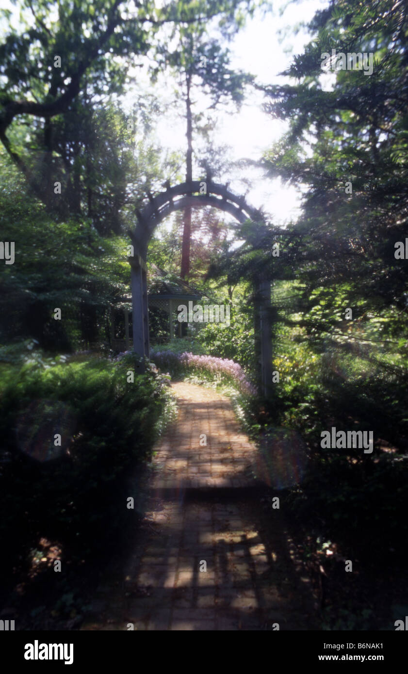 back yard garden path with lattice arch way Stock Photo - Alamy