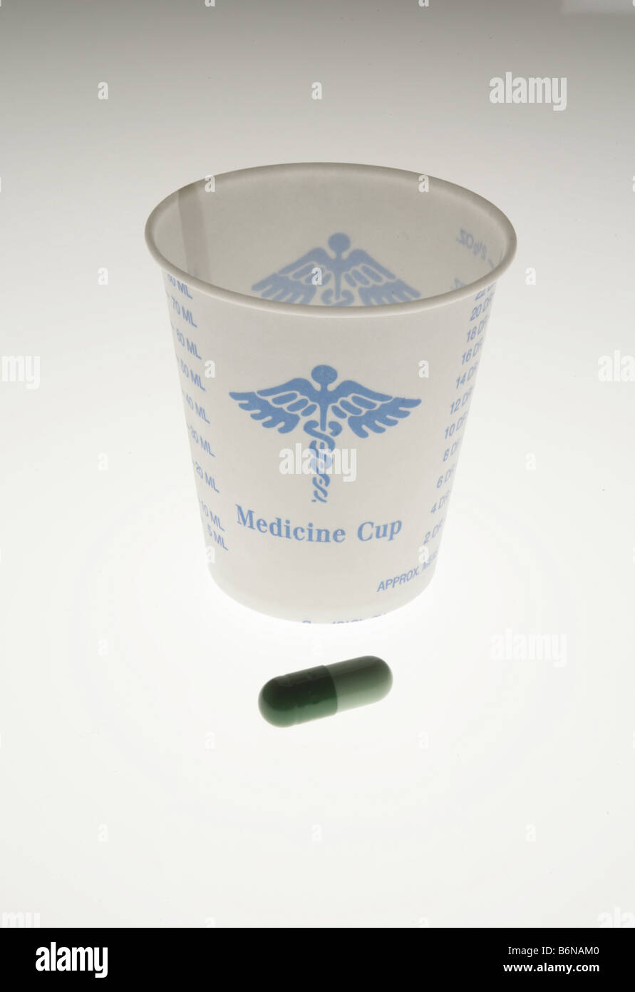 medicine cup and pill Stock Photo - Alamy