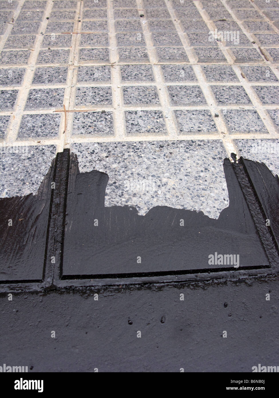 Black paint on footpath Stock Photo - Alamy