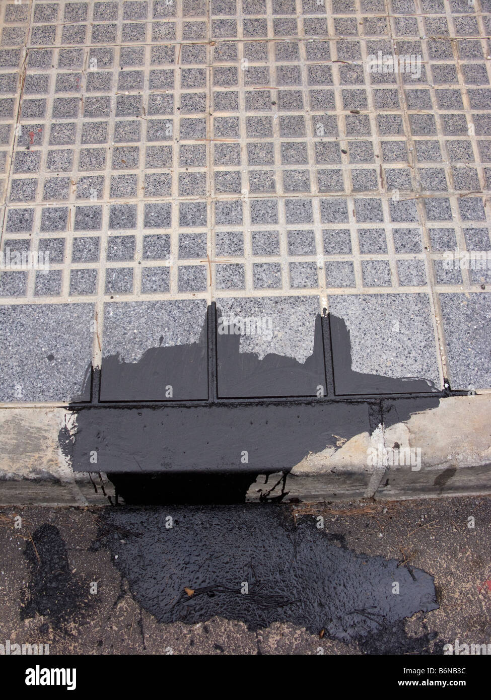 Black paint on footpath Stock Photo - Alamy