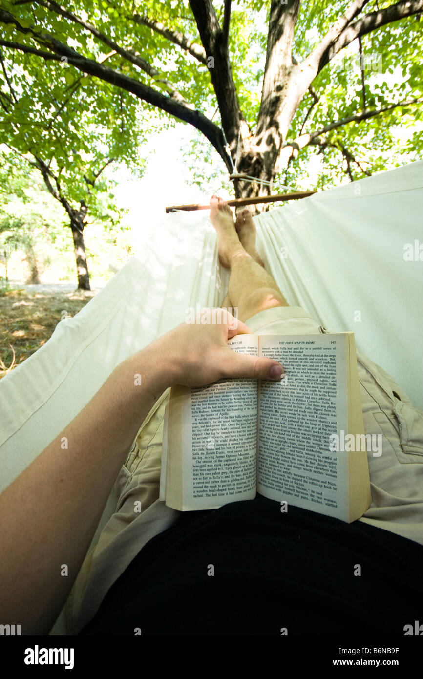 Reading a book in a hammock Stock Photo - Alamy