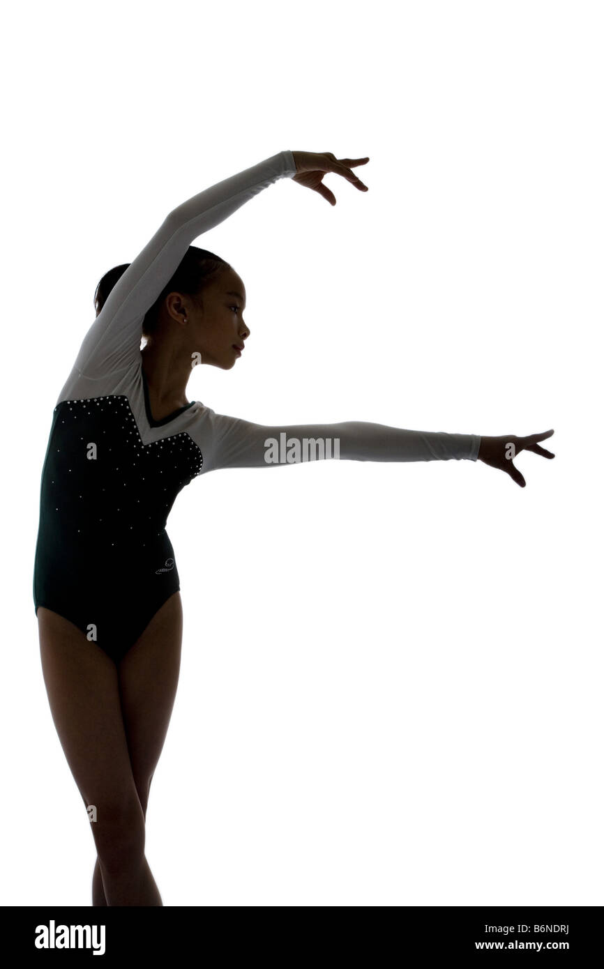 Girl practicing gymnastic pose on pad silhouette Stock Photo - Alamy