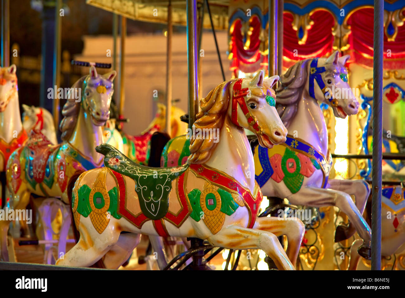 Old-fashioned roundabout with horses Stock Photo - Alamy