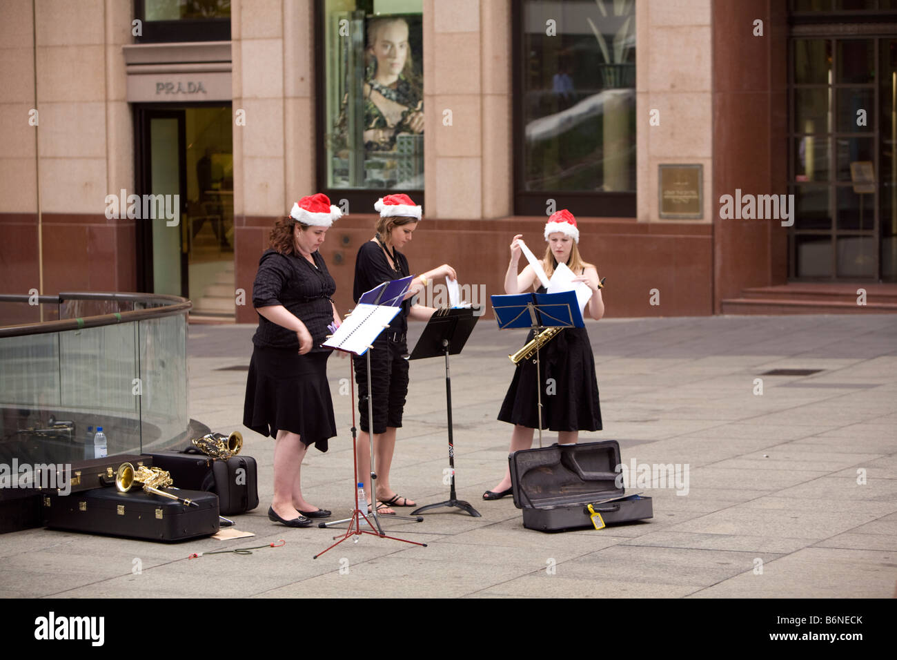 three female buskers wearing christmas hats in martin place,sydney ...