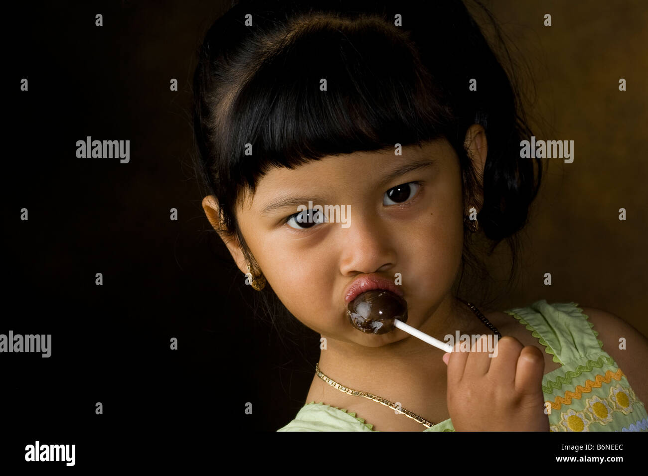 Hispanic girl enjoying candy Stock Photo - Alamy