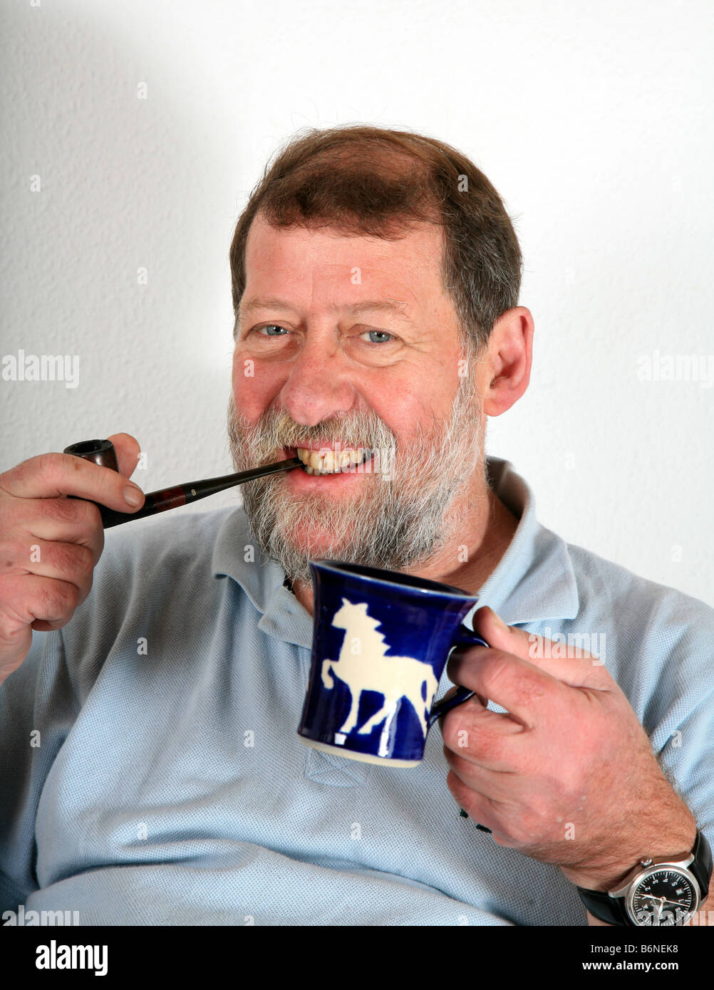 Man smoking a pipe and drinking coffee Stock Photo - Alamy