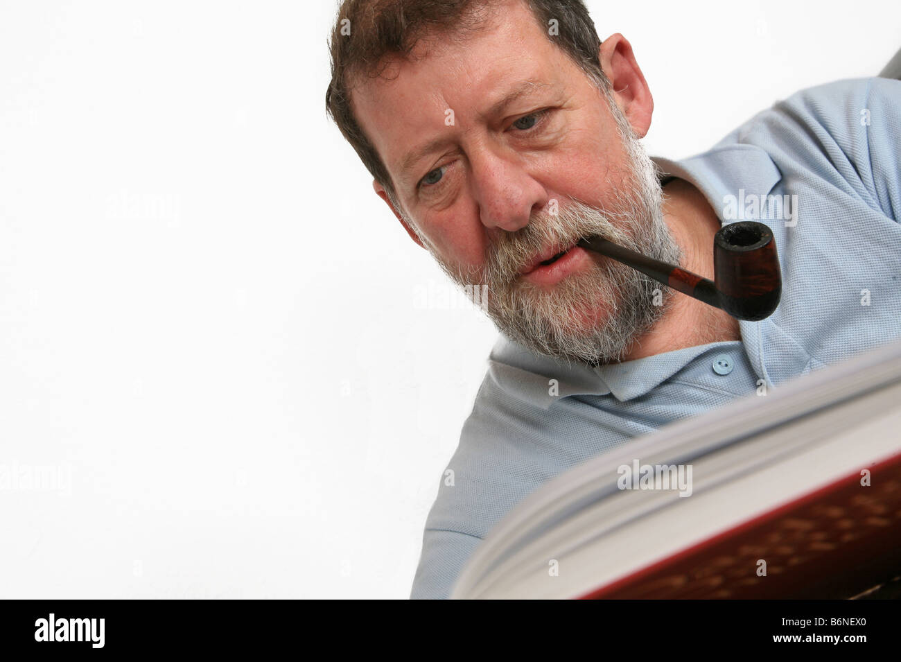 simple portrait of mature caucasian man reading a book Stock Photo - Alamy