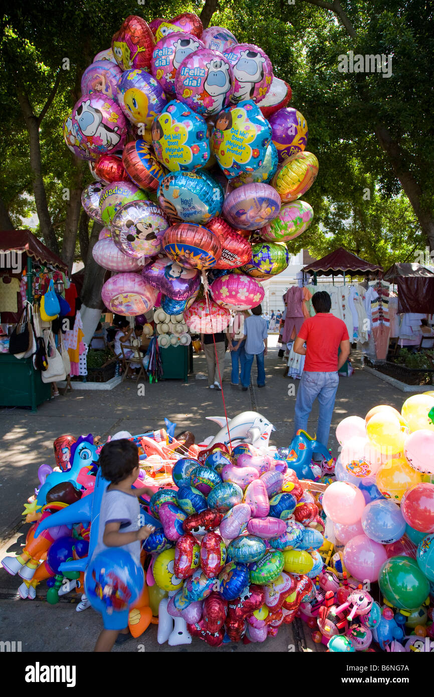 Boy reaching for coloured balloons Plaza del Independencia Merida ...