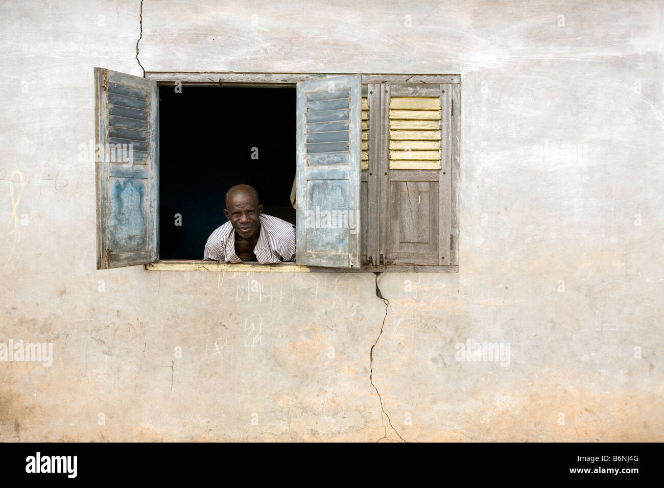 Ghana, west coast, Senya Beraku. Fort Good Hope, Local man in window ...