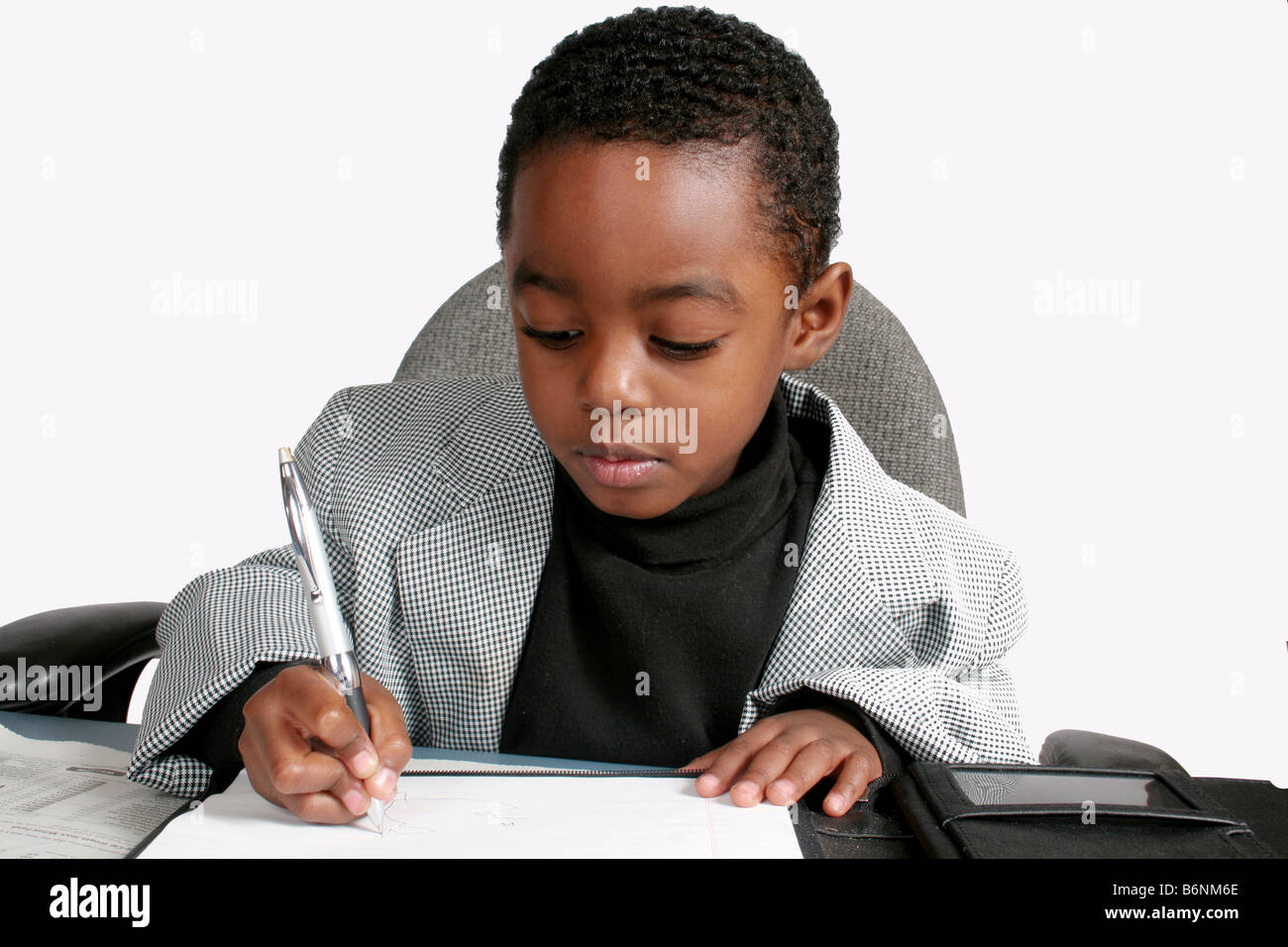 Young african american boy writing with a pen Stock Photo - Alamy