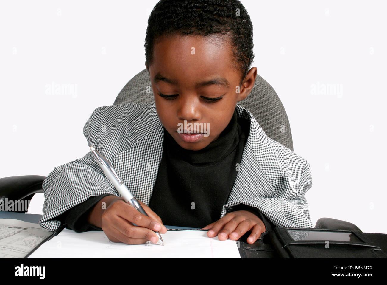 Young african american boy writing with a pen Stock Photo - Alamy