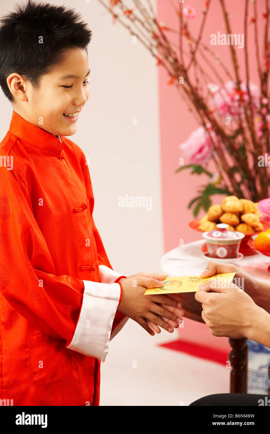 boy receiving red packet from man Stock Photo - Alamy