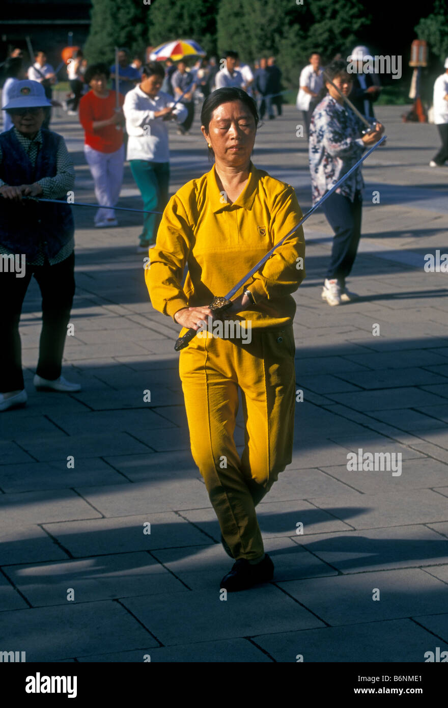 Chinese woman performing taichi, morning exercise, Temple of Heaven ...