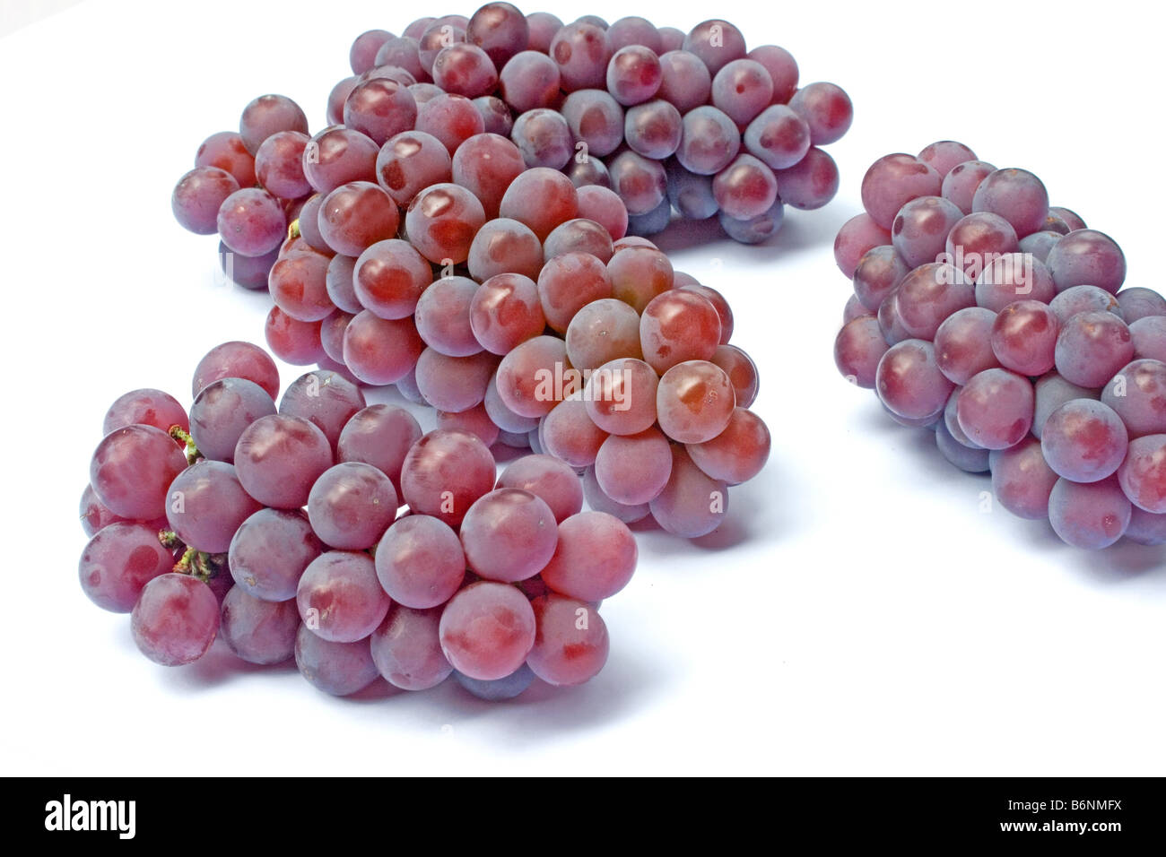 Red grapes on white background Stock Photo - Alamy