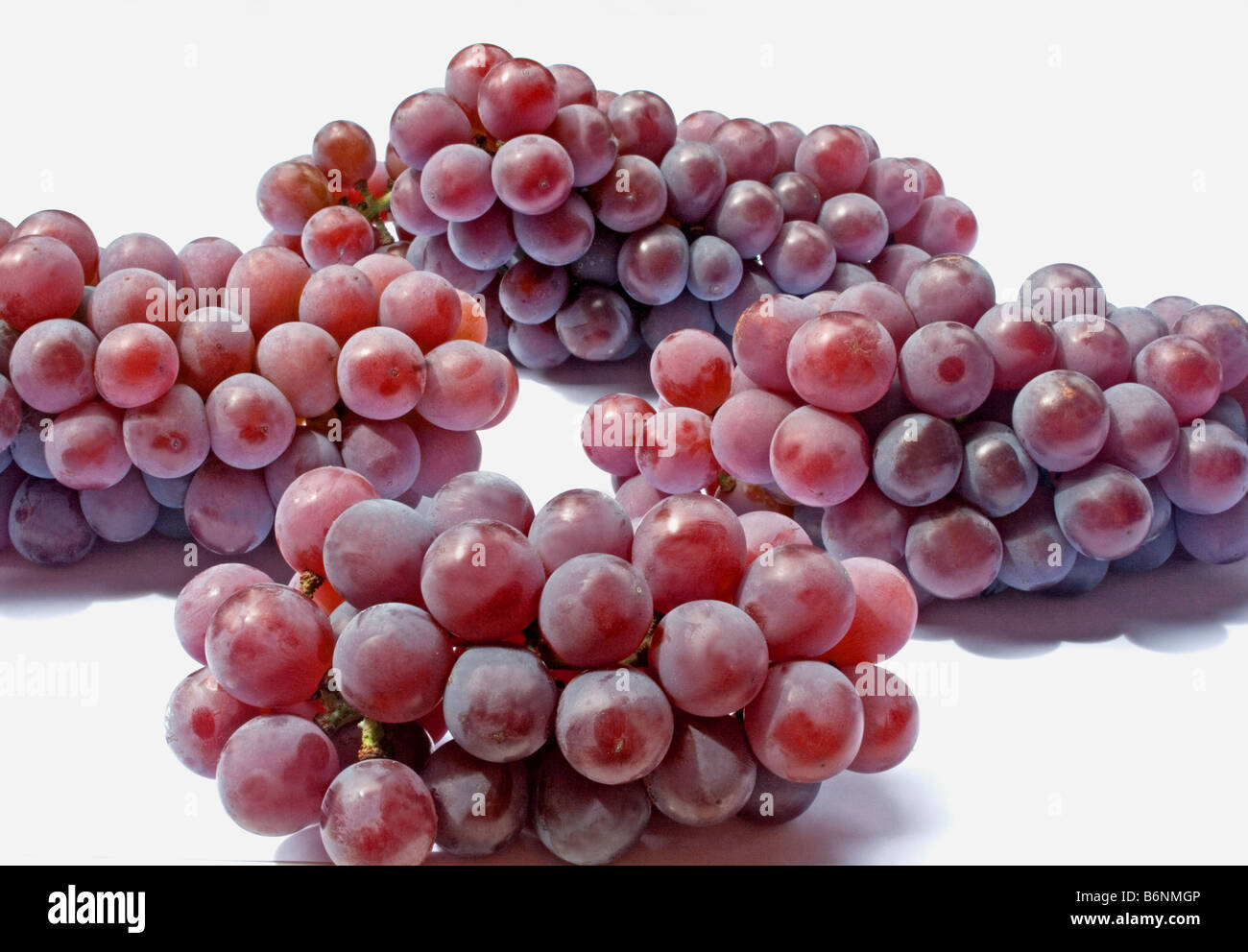 Red grapes on white background Stock Photo - Alamy