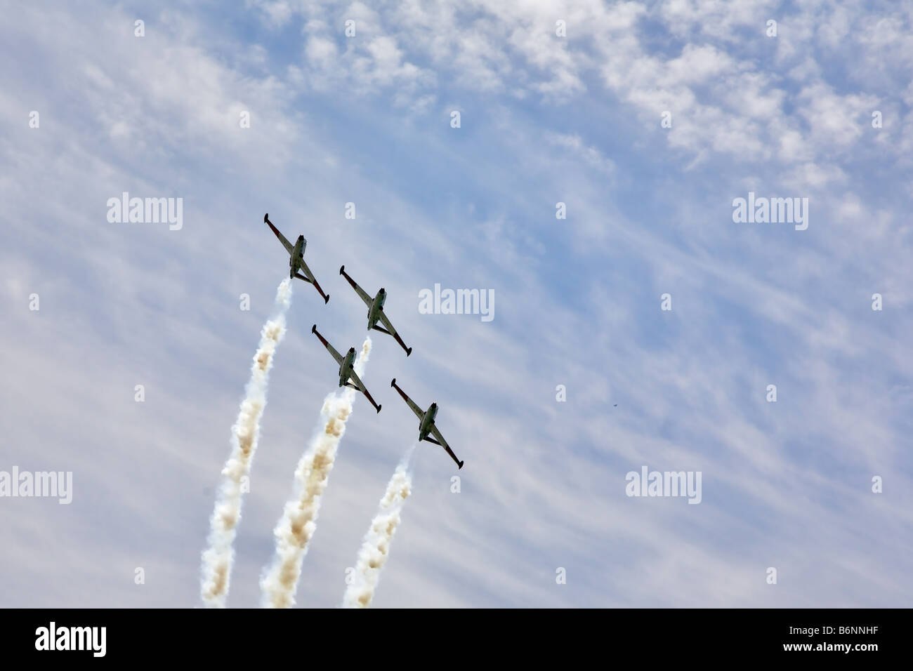 Synchronous flight of four sparkling planes on air parade Stock Photo ...