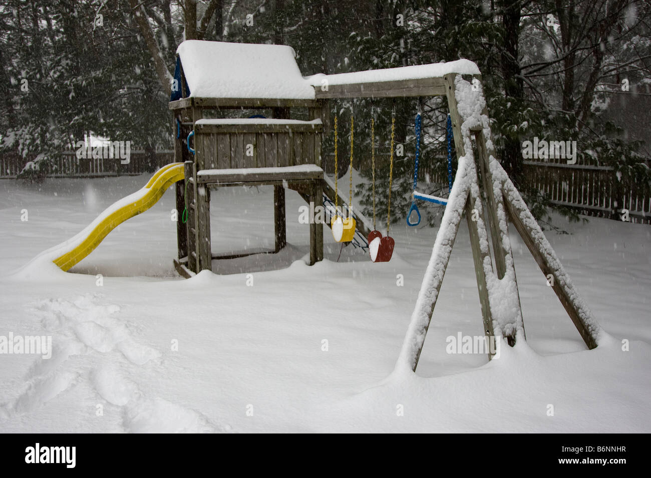 A swing set during a snowstorm Stock Photo - Alamy
