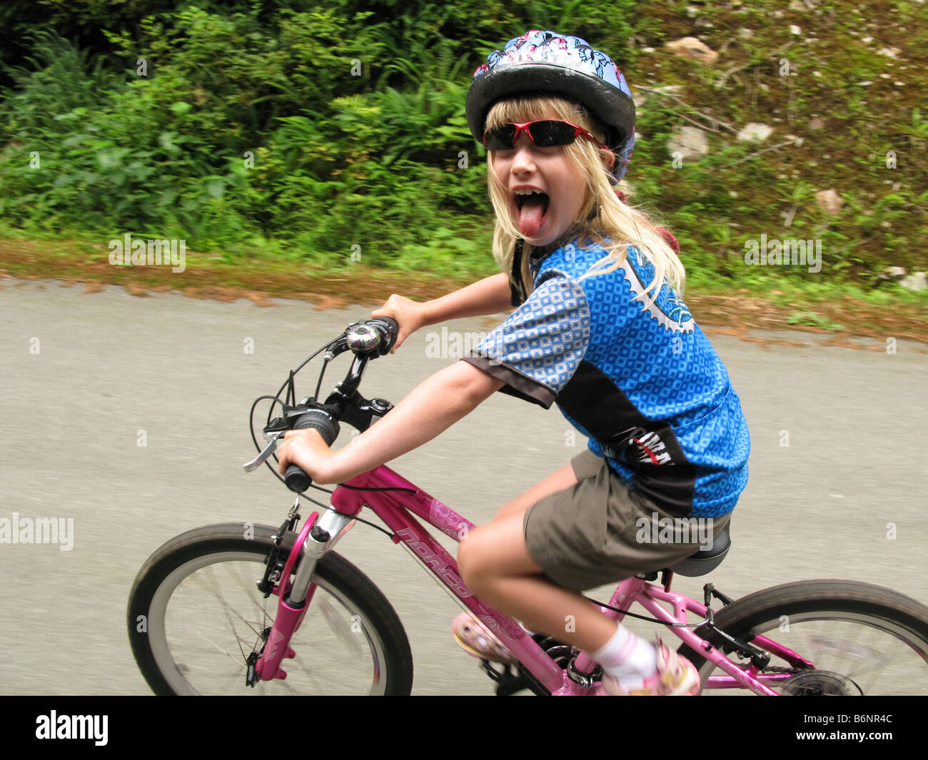 Young girl cycling Stock Photo - Alamy