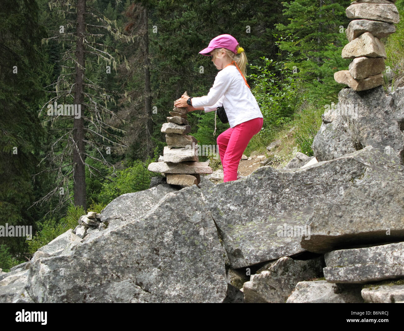 Child stacking rocks hi-res stock photography and images - Alamy