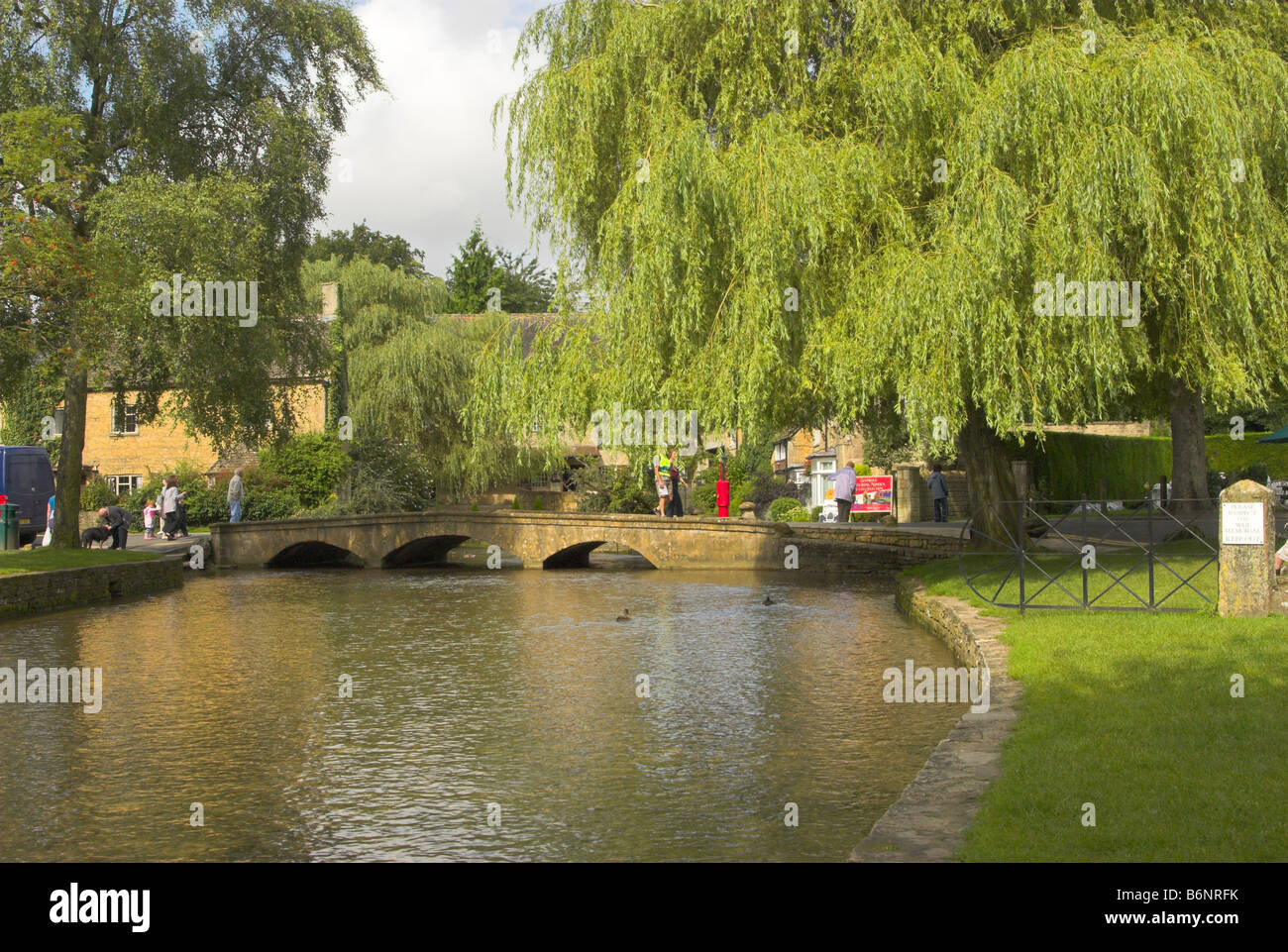The River Windrush flowing through the picturesque Cotswold village of ...