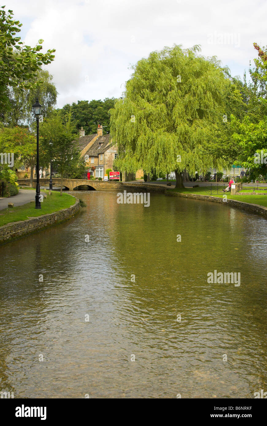 The River Windrush flowing through the picturesque Cotswold village of ...