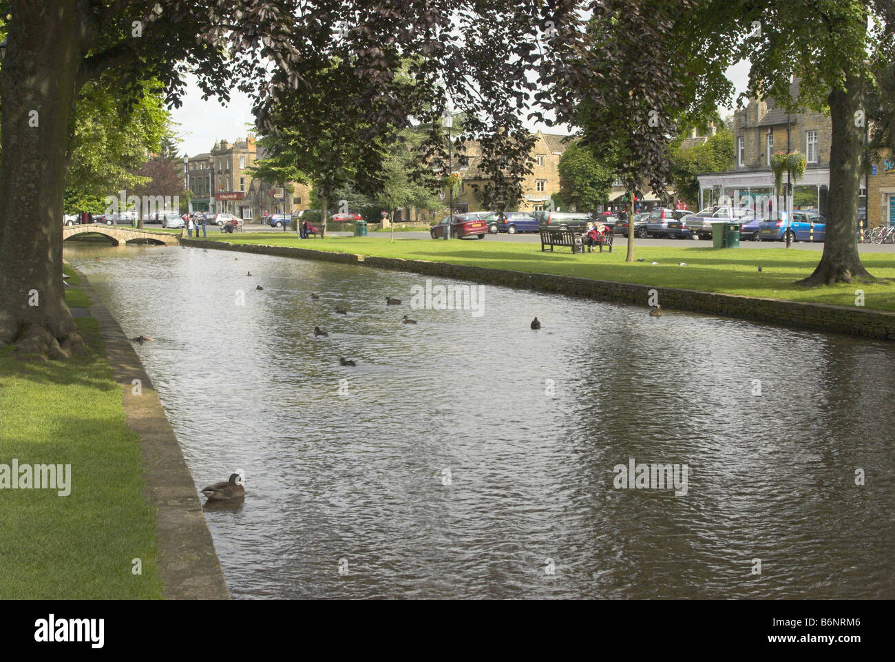 The River Windrush flowing through the picturesque Cotswold village of ...
