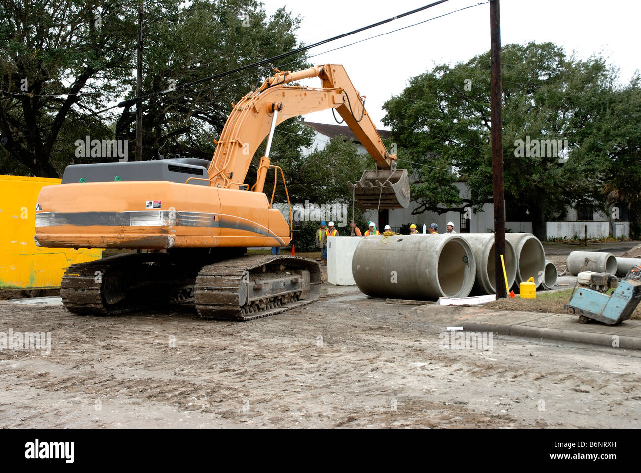 Ditch digging machine digging ditch for drain pipe.Drain pipe in ...