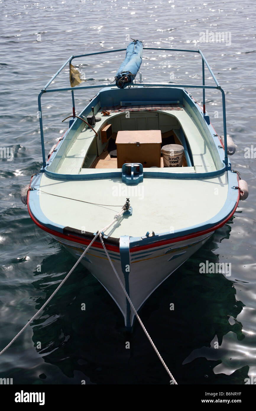 small wooden fishing boat anchored Stock Photo - Alamy