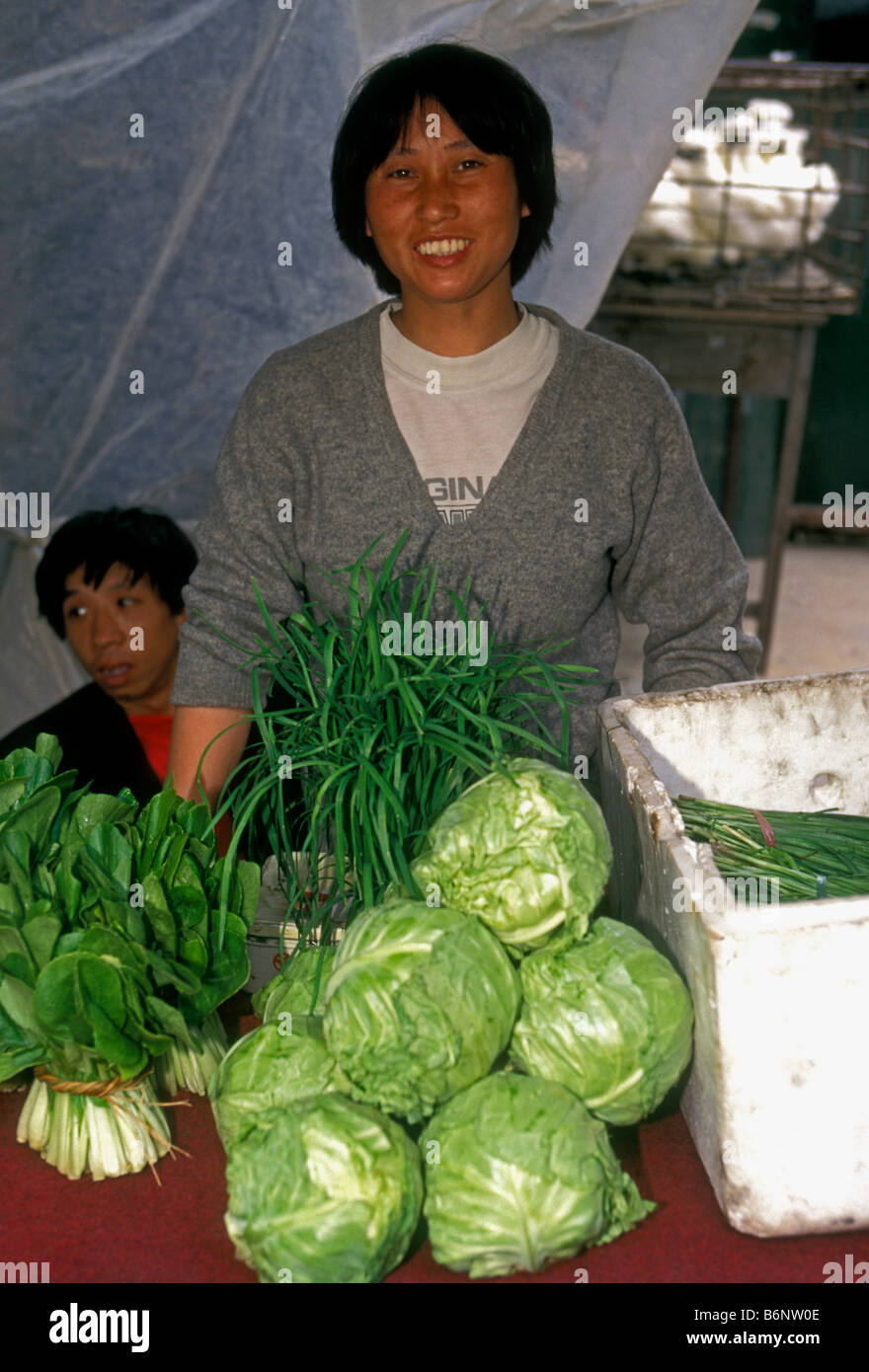 Chinese woman, eye contact, front view, street vendor selling cabbage ...
