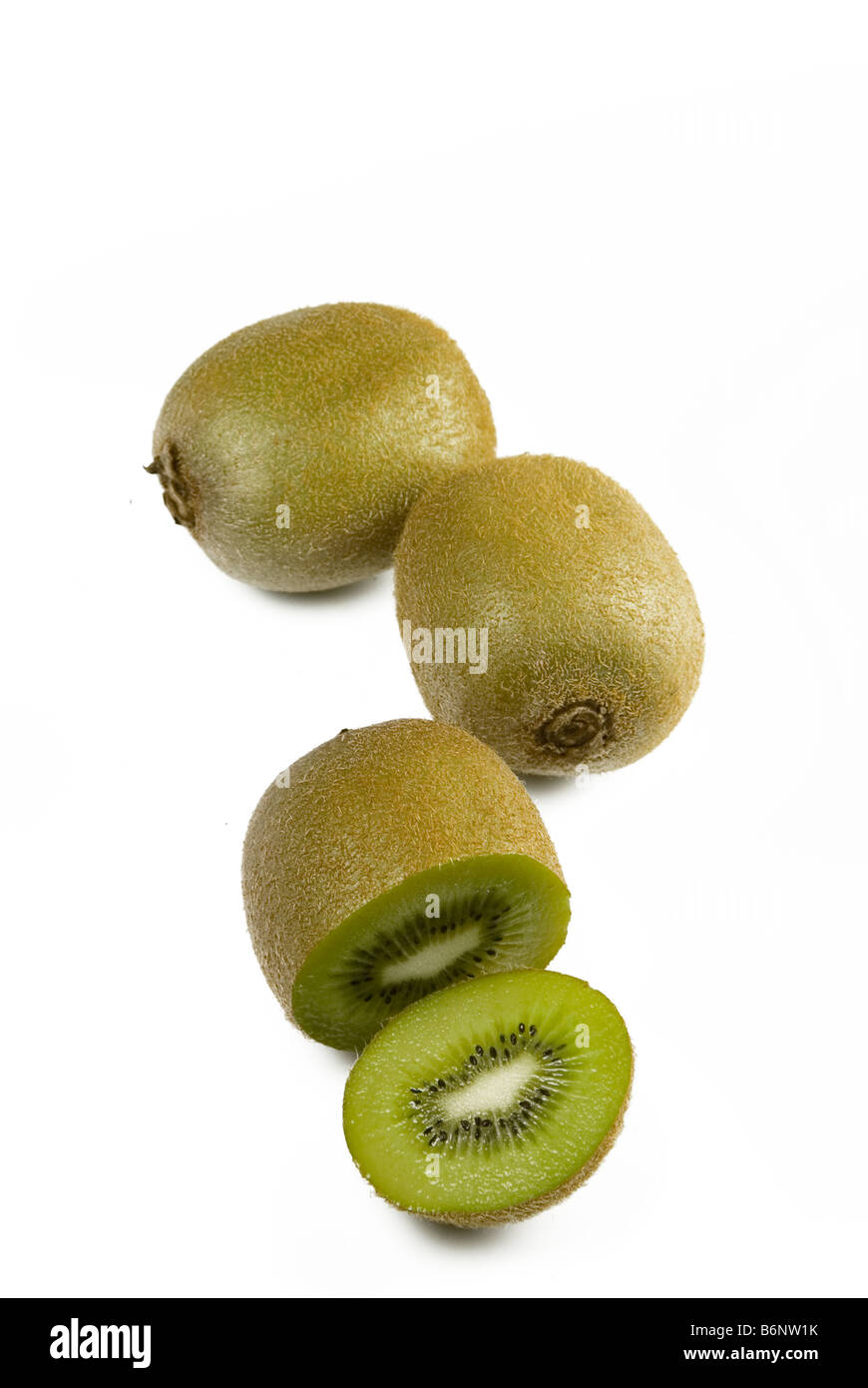 Whole kiwis and cut piece of kiwi on white background Stock Photo - Alamy