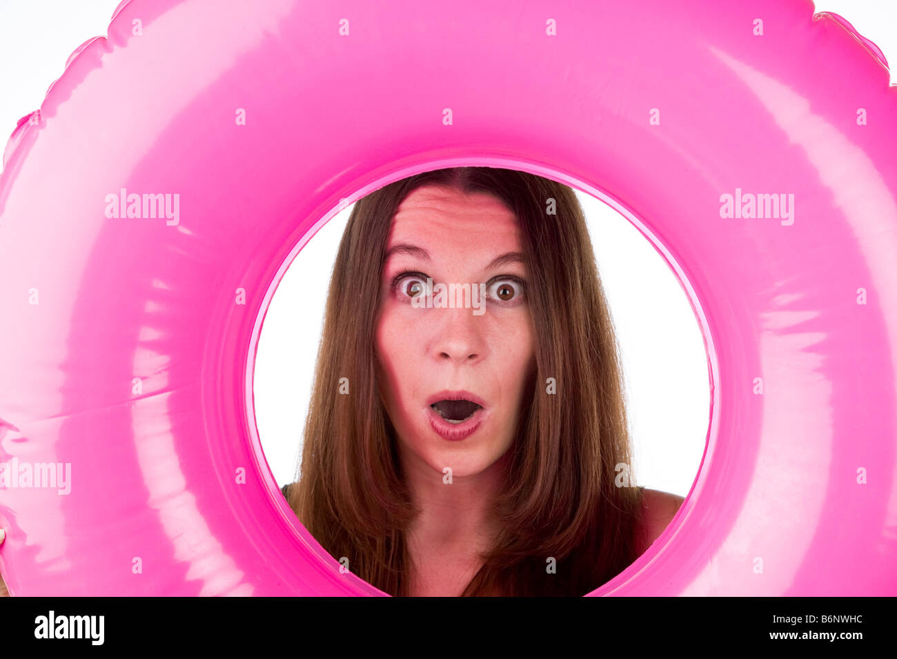 Pretty woman with a beach float ring against white Stock Photo - Alamy