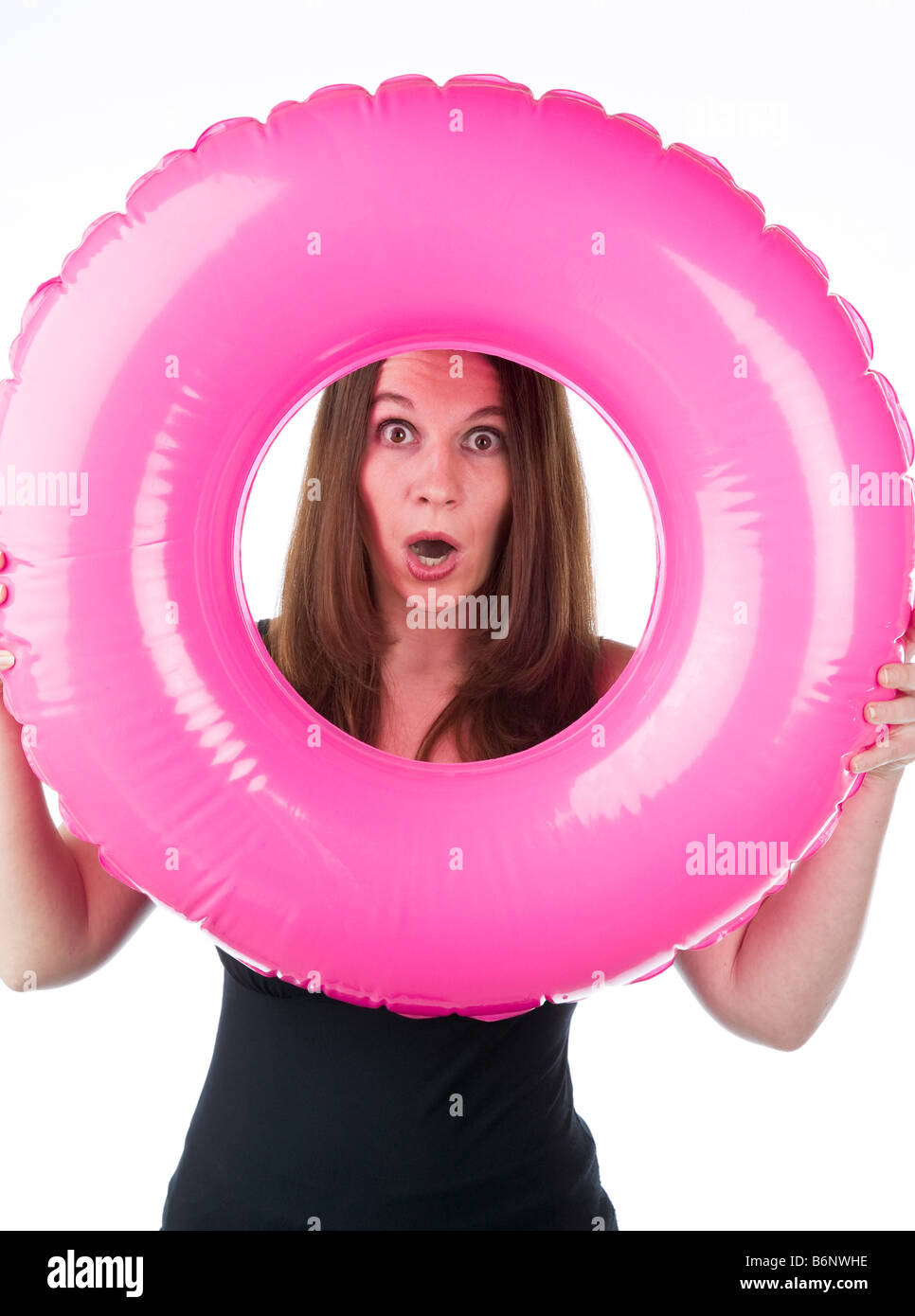 Pretty woman with a beach float ring against white Stock Photo - Alamy