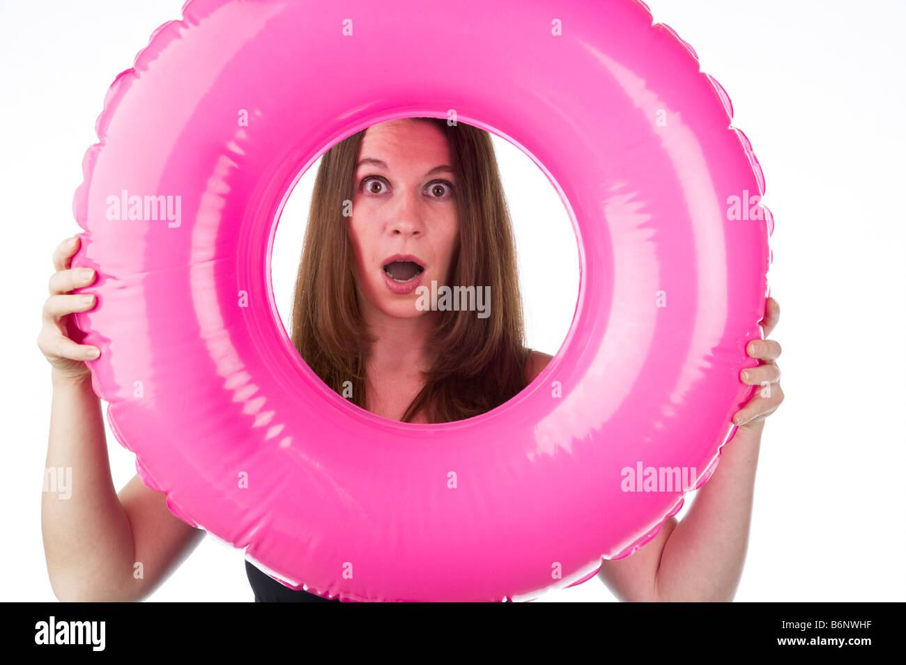 Pretty woman with a beach float ring against white Stock Photo - Alamy