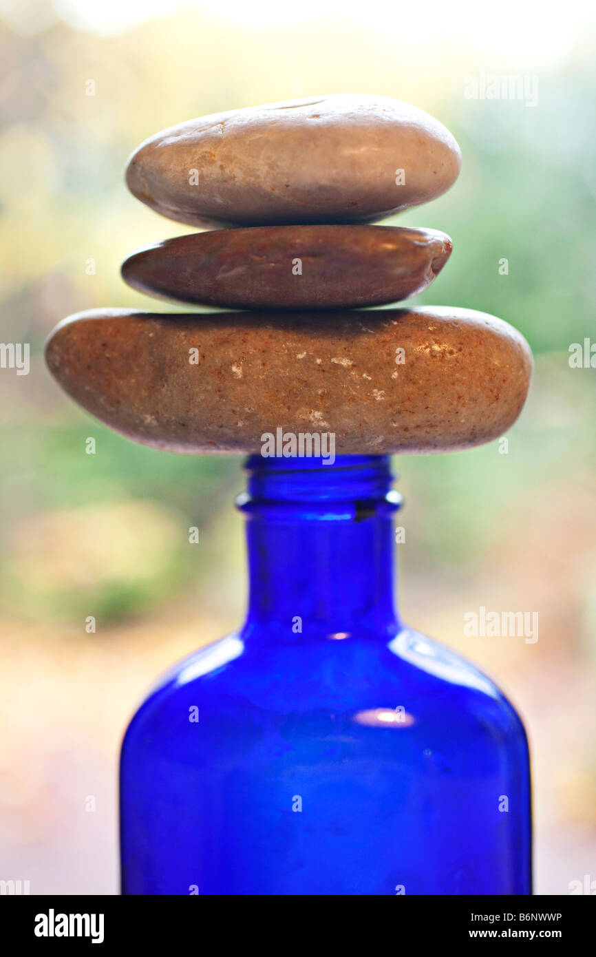 Rocks and blue bottle Stock Photo - Alamy