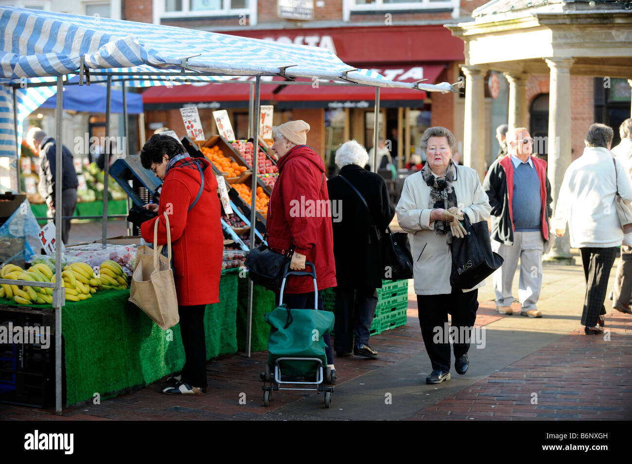 Shopping at a fruit and vegetable market stall in Worthing UK Stock ...