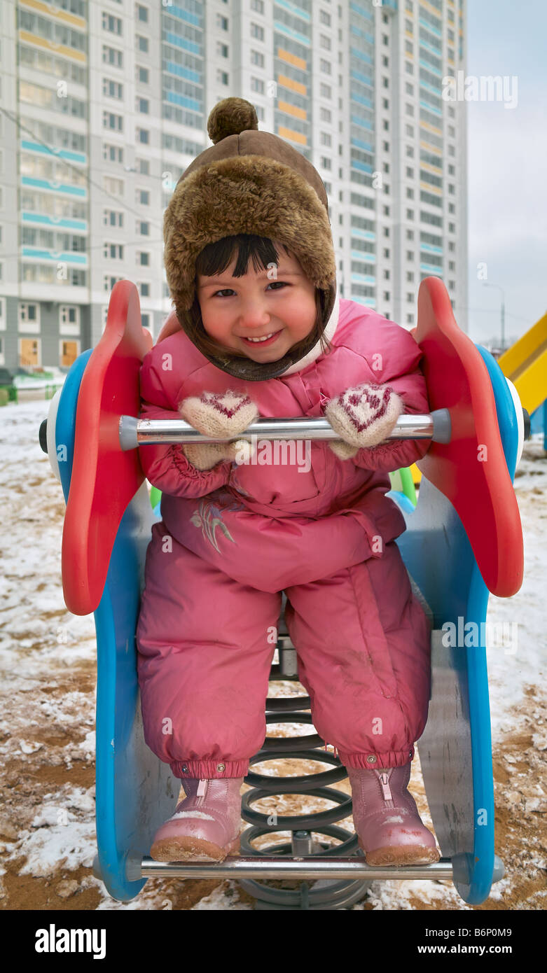 Little girl plays outdoor and pose for photograph dingle dangle on ...