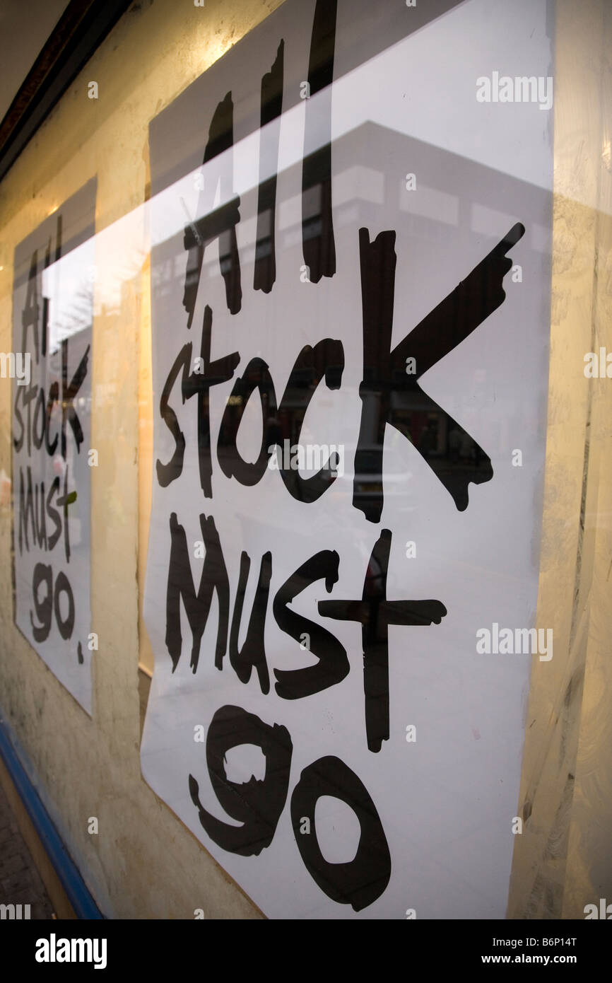 Posters in a shop window announce that "all stock must go Stock Photo ...
