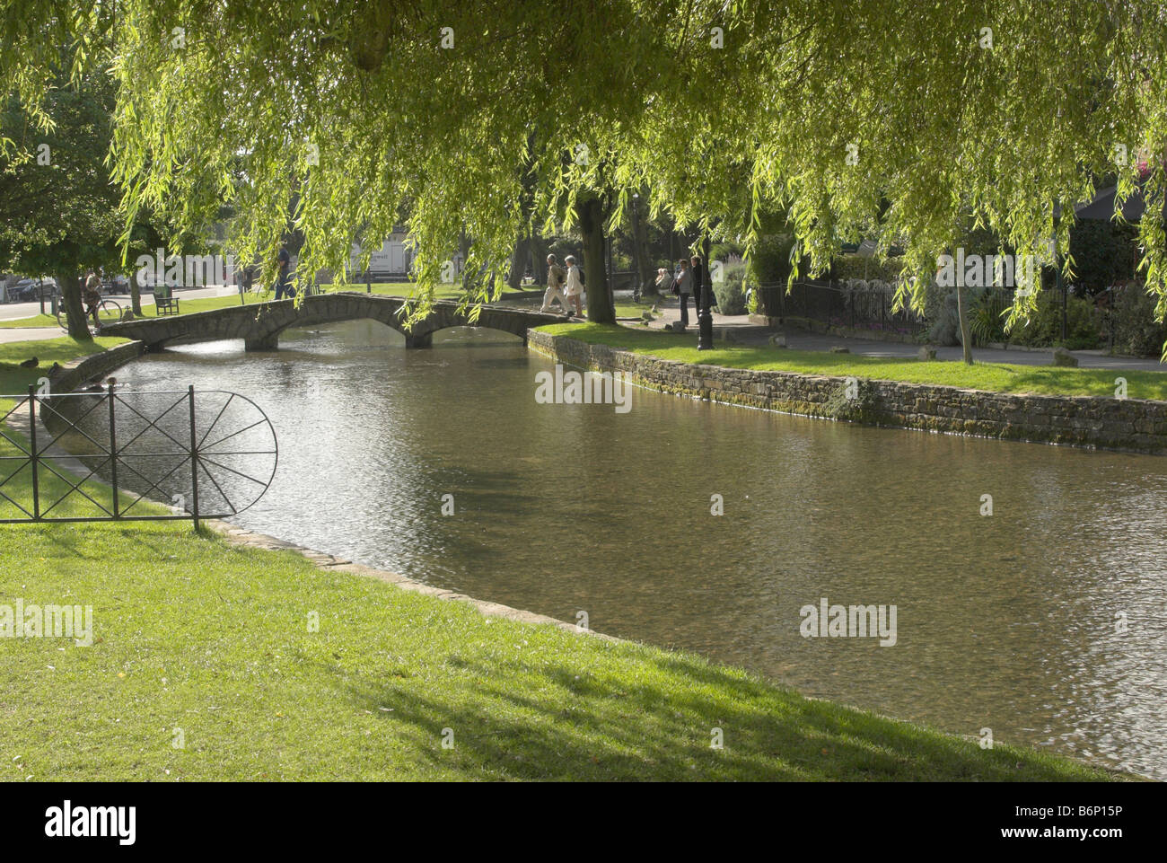 The River Windrush flowing through the picturesque Cotswold village of ...