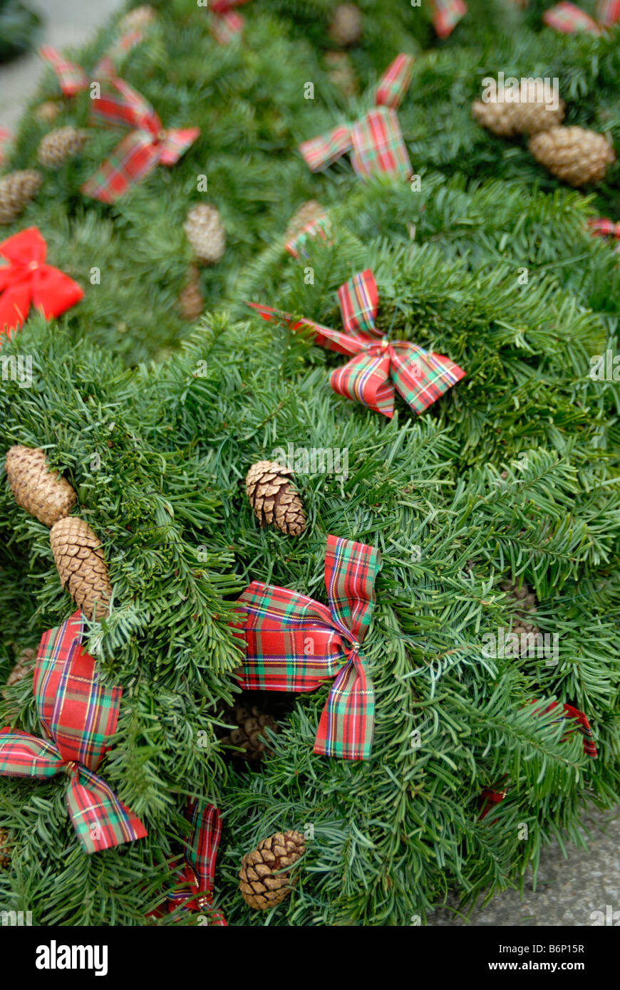 Christmas wreaths with ribbons and pine cones on display Stock Photo ...