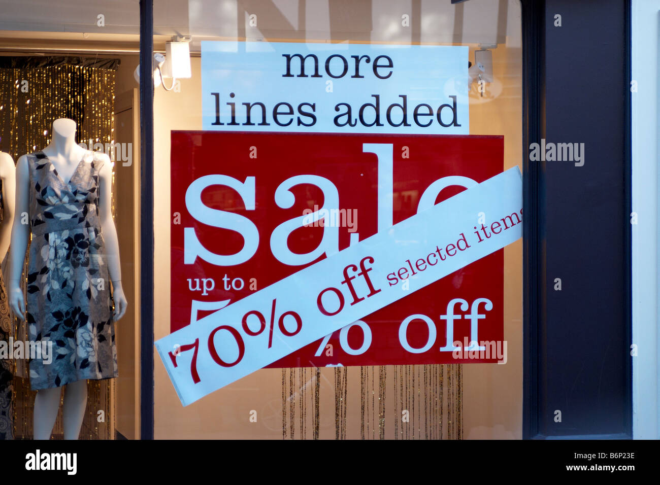 Sale sign in a shop window with 70% discounts advertised Stock Photo ...