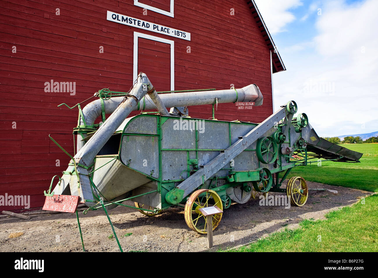 Image of an antique grain thresher and auger on display at the Olmstead ...