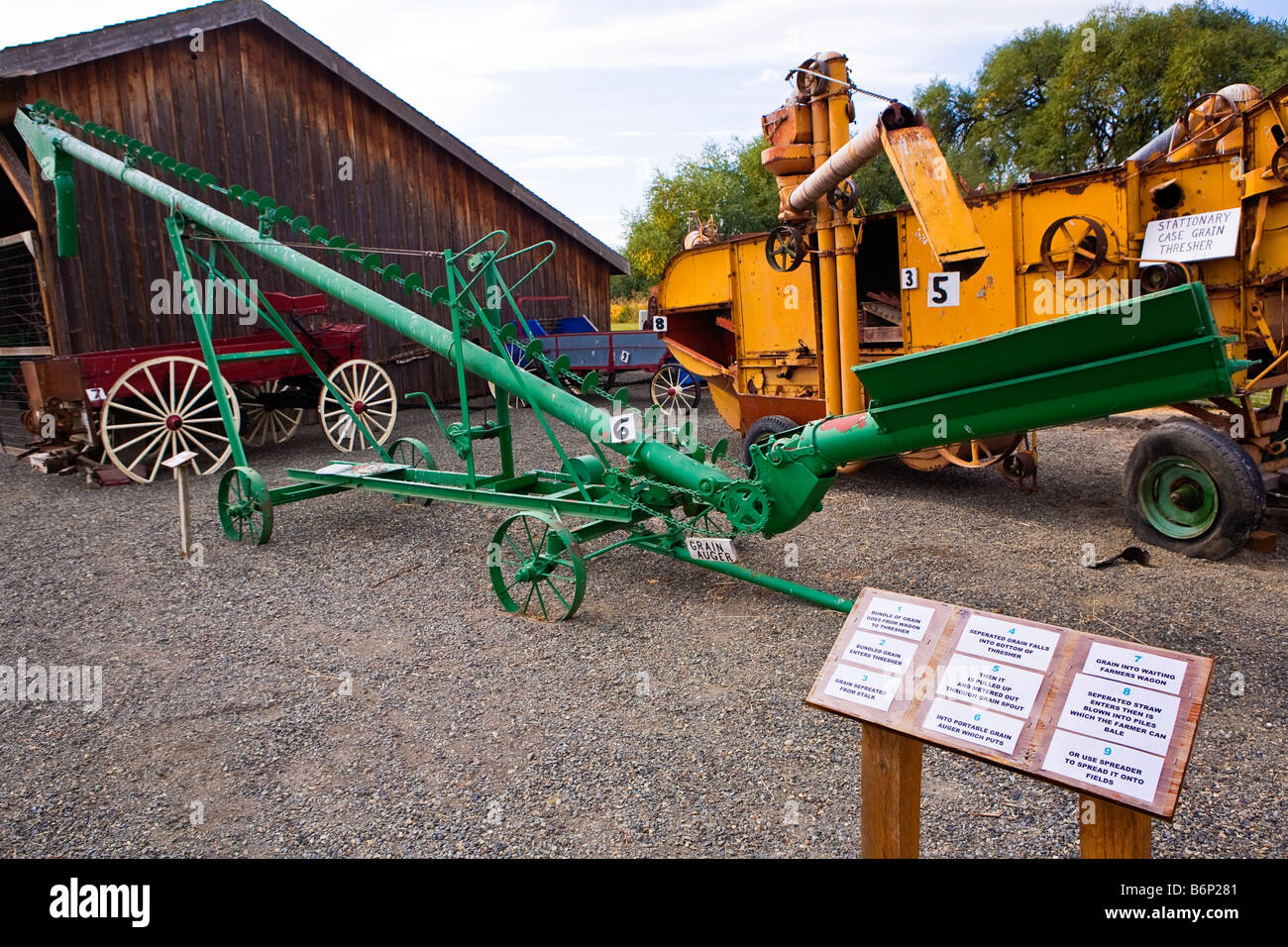 Image of an antique stationary case grain thresher and auger on display ...
