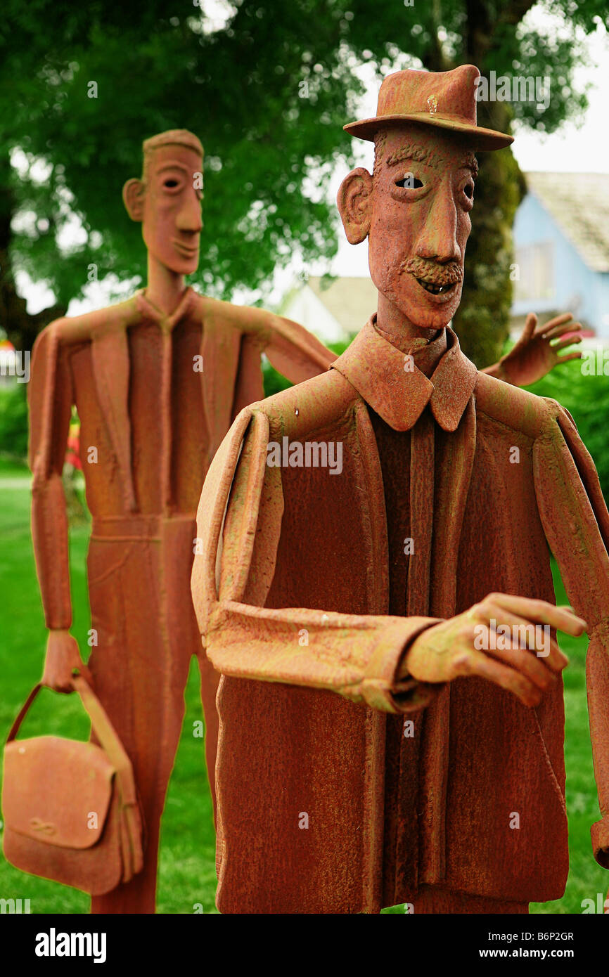 Image of a metal cutout sculpture showing two older men in work ...