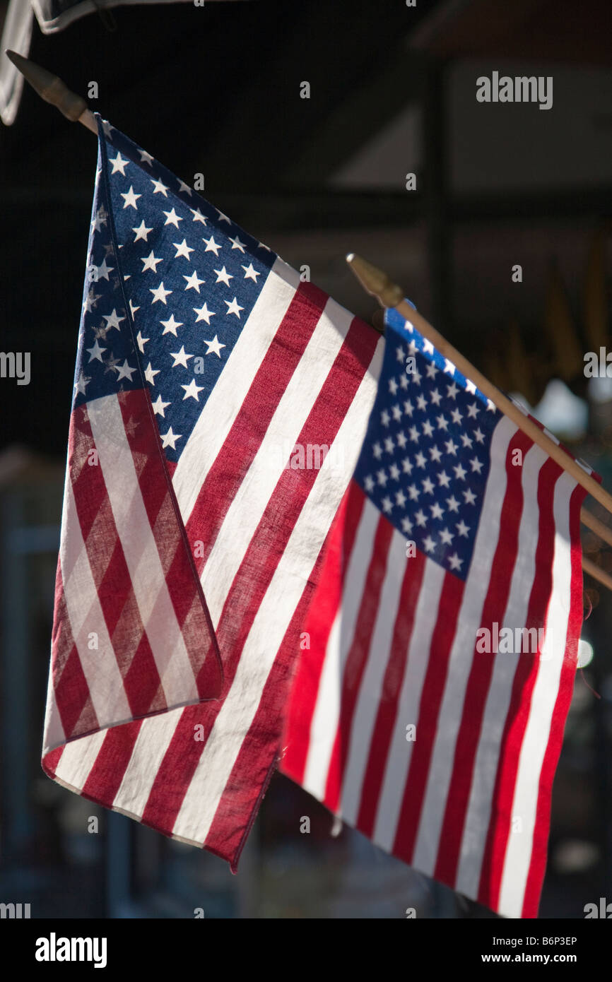 Two American flags are back lit against a dark background Stock Photo ...