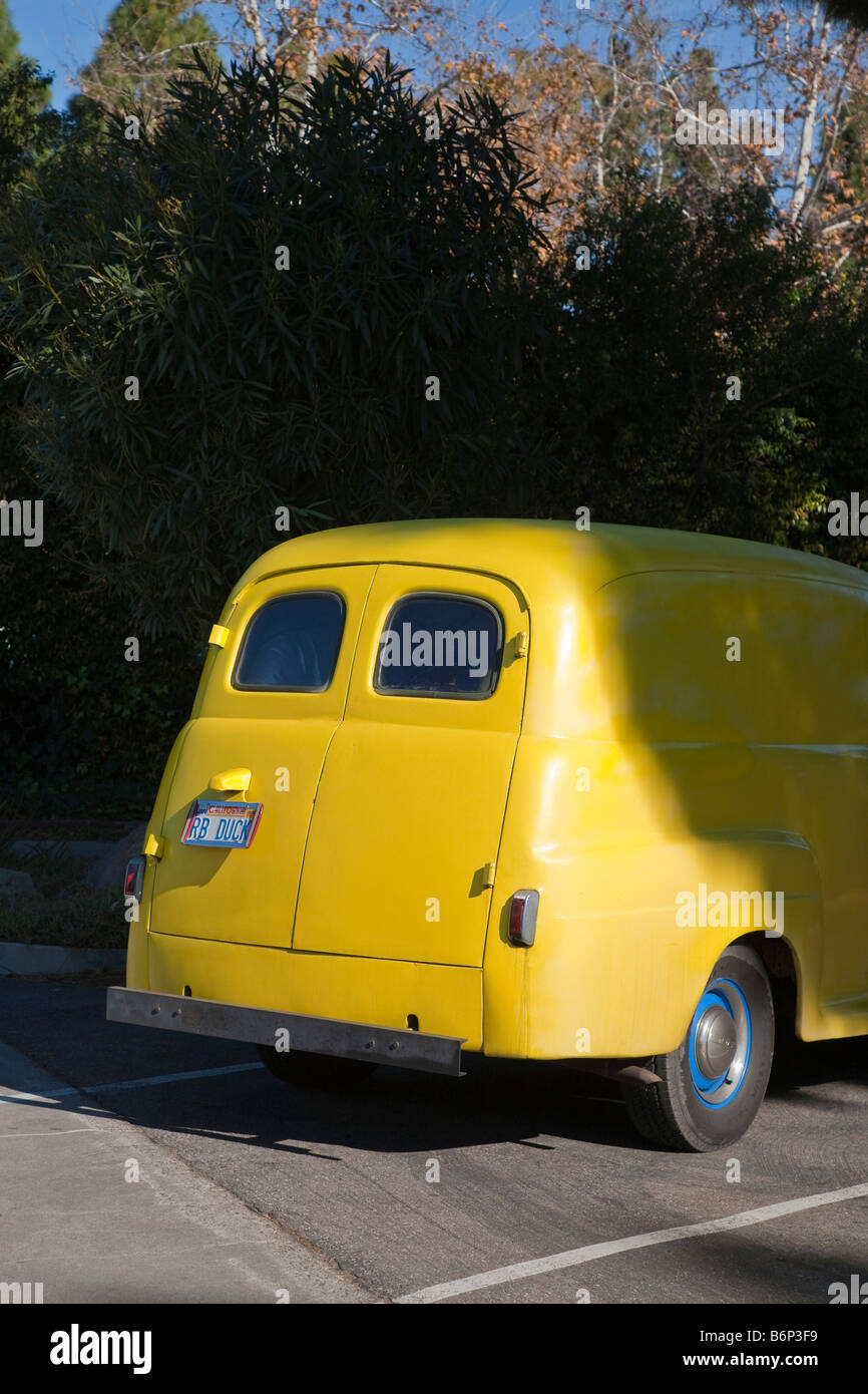 A rear view of a very brightly colored yellow panel truck from the ...
