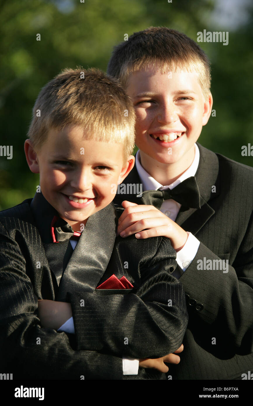 Two young lads (brothers) dressed in dinner suits posing for a portrait ...