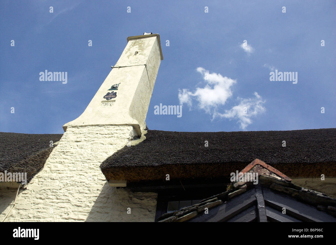 An old chimney with fire insurance badges in Porlock in Devon Stock ...